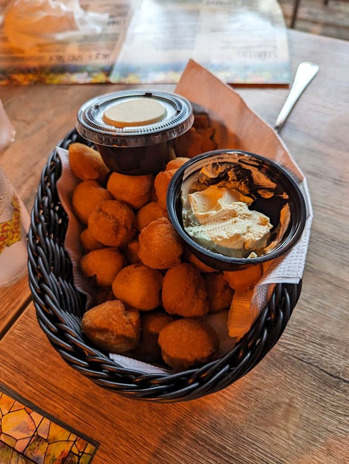 Golden hushpuppies that crunch then melt, served with honey butter that'll make you question why you've wasted time on lesser bread baskets.