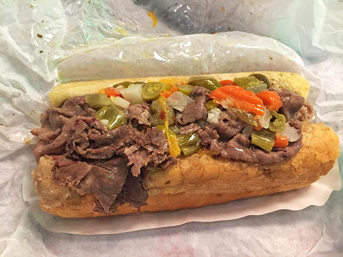 Behold the Italian beef masterpiece: tender meat, tangy giardiniera, and pure sandwich poetry in action.