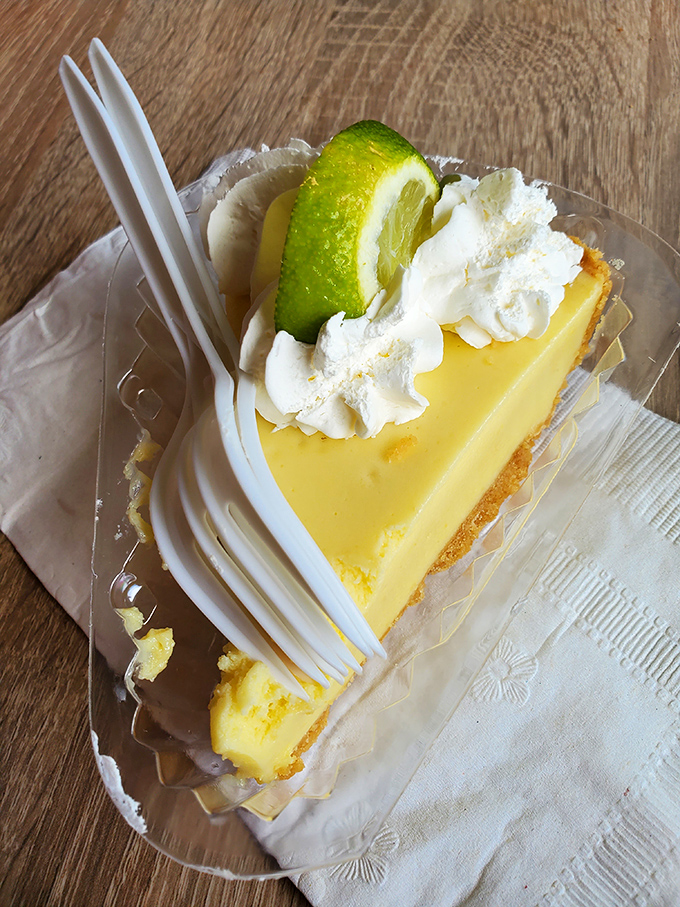 Key lime pie perfection: pale yellow filling, cloud-like whipped cream, and a graham cracker crust that would make Florida's founding fathers weep with joy.
