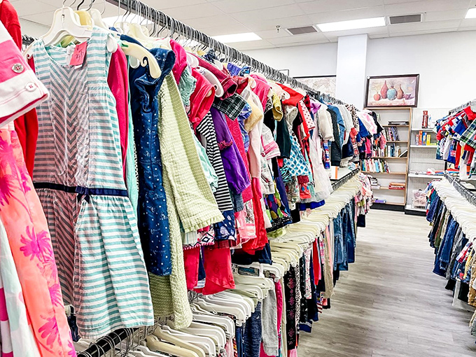 A rainbow of children's clothes creates a colorful parade of possibilities, where tiny fashionistas can build wardrobes without breaking their parents' piggy banks.