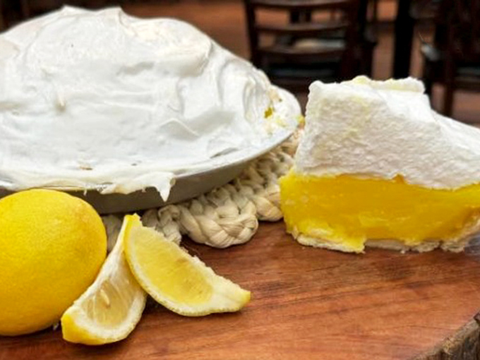 Sunshine-yellow filling crowned with clouds of meringue &ndash; this slice of lemon heaven isn't just dessert, it's a religious experience worth converting for.