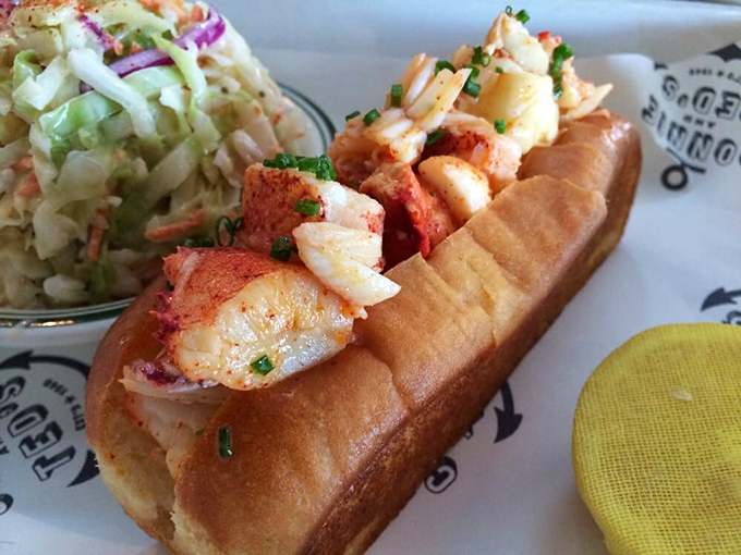 Behold the lobster roll in its natural habitat&mdash;buttery, toasted perfection cradling sweet chunks of lobster. The coleslaw isn't jealous; it knows its supporting role.