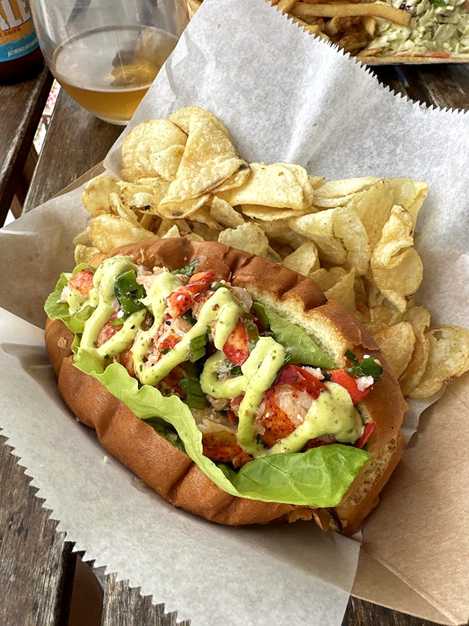 Fresh lobster nestled in a pillowy roll with a splash of color from fresh veggies&mdash;proof that simplicity, done right, is the ultimate luxury.
