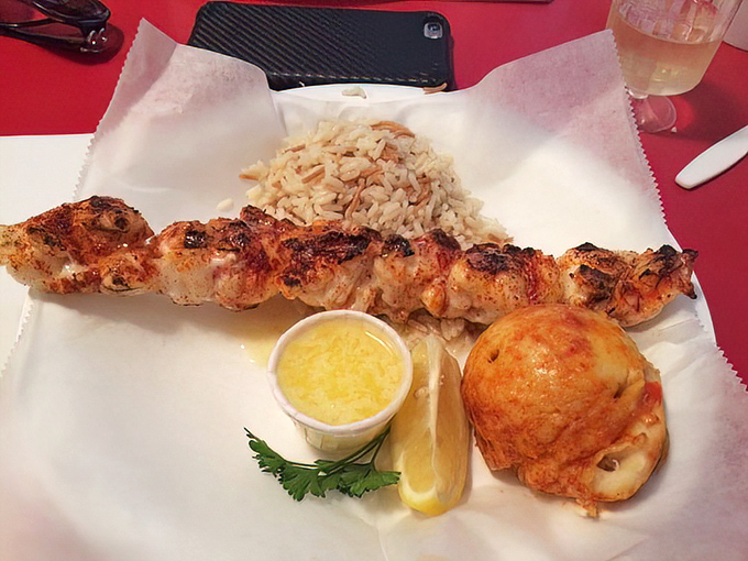 Lobster on a skewer: where simplicity meets luxury. That drawn butter cup isn't optional&mdash;it's essential equipment for this maritime adventure.
