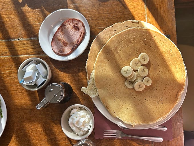 Pancakes so massive they deserve their own zip code, topped with bananas that didn't dare show up without bringing friends.
