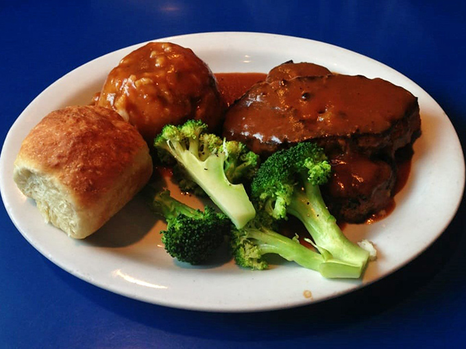 Behold the star of the show &ndash; meatloaf that would make your grandmother both jealous and proud, swimming in gravy that deserves its own fan club.