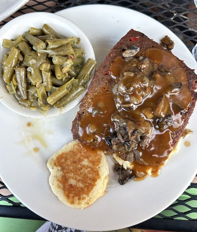That meatloaf isn't just dinner, it's an event &ndash; crowned with savory gravy and flanked by green beans that didn't escape their bacon destiny.
