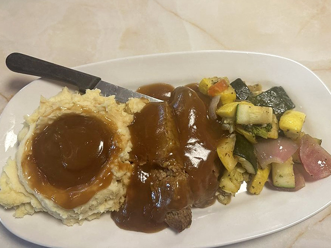 Mama's meatloaf doesn't mess around&mdash;tender, savory, and smothered in gravy that would make your grandmother nod in approval.