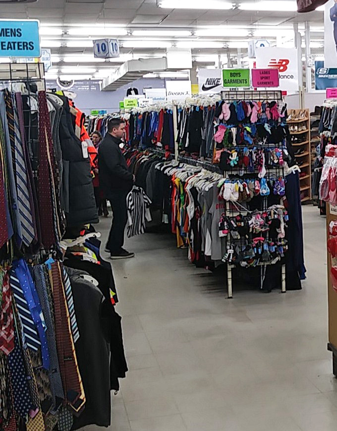 The men's section: where brand names and everyday basics coexist in perfect harmony, waiting for their second chance at fashion greatness.