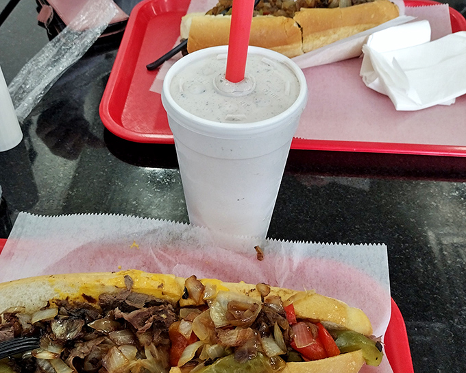 That milkshake moment &ndash; when your straw meets creamy perfection alongside a proper cheesesteak. Life's simple pleasures in perfect harmony.