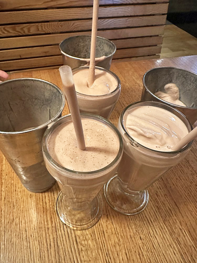 These aren't just milkshakes; they're creamy monuments to dairy-free deliciousness, served with the metal mixing container on the side—essentially giving you a shake and a half.
