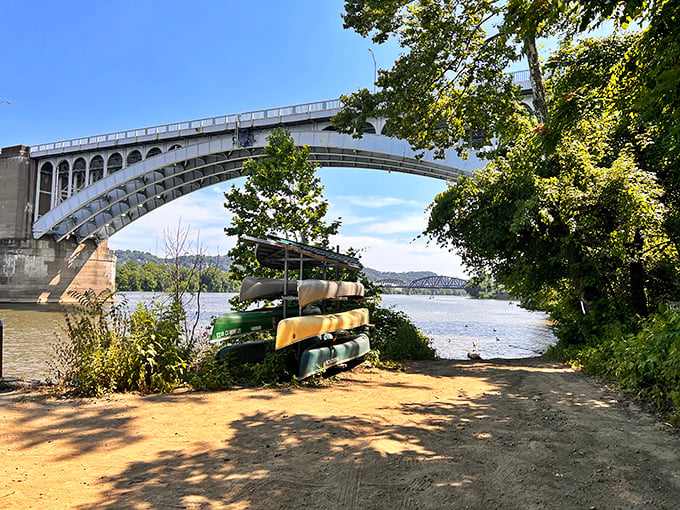 The Allegheny River provides a peaceful backdrop for outdoor enthusiasts, with canoes stacked ready for adventure just steps from Millvale's bustling streets.