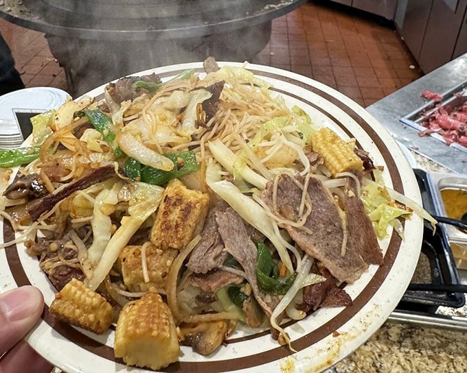 A mountain of noodles, vegetables, and protein creates a symphony of textures in this Mongolian BBQ plate &ndash; proof that sometimes more is definitely more.