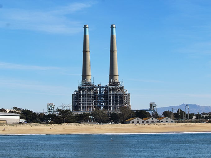 The twin sentinels of Moss Landing stand guard. These iconic smokestacks serve as the unofficial lighthouse for travelers seeking this hidden coastal gem.