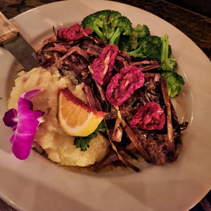 Not just any steak—this plate is dinner and a show. The mashed potatoes are the unsung hero, while those edible flowers aren't just pretty faces.