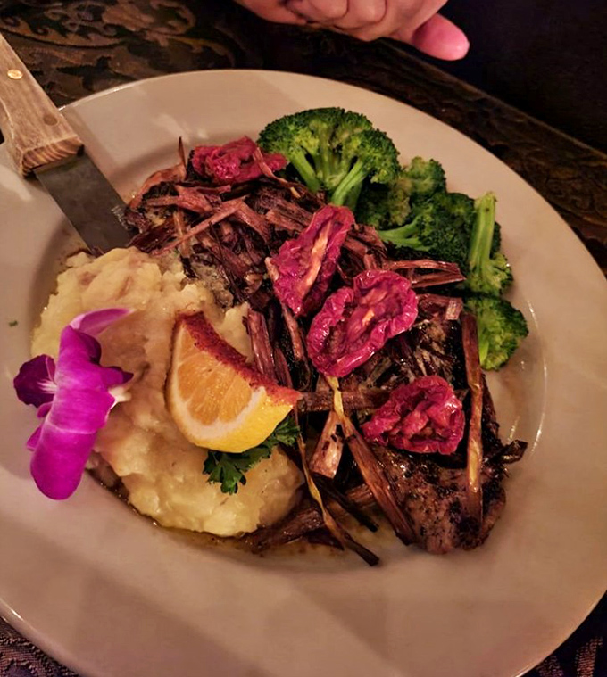 A perfectly seared steak arrives like edible artwork&mdash;mashed potatoes as the canvas, crisp broccoli for color, and those vibrant garnishes adding the final masterful touch. 