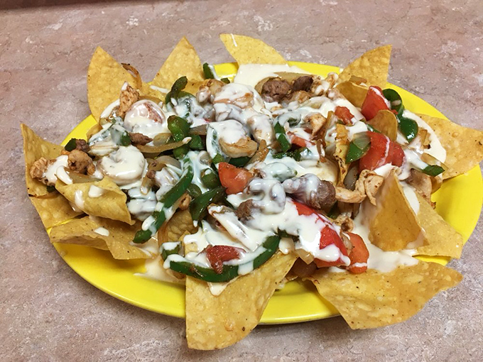 Nachos that require a strategy meeting before eating. Each chip stands ready for battle, armed with chicken, cheese, and enough toppings to make sharing a moral dilemma. 