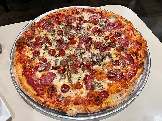 Pizza perfection doesn't need fancy words—just look at those crispy pepperoni cups curling up to hold their little pools of savory oil. Poetry in pizza form.