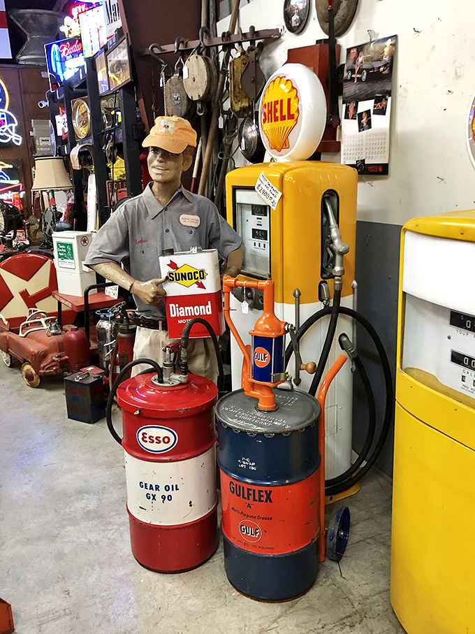 This gas station attendant hasn't pumped fuel since Nixon was president, but he's still faithfully standing watch over vintage petroleum treasures.