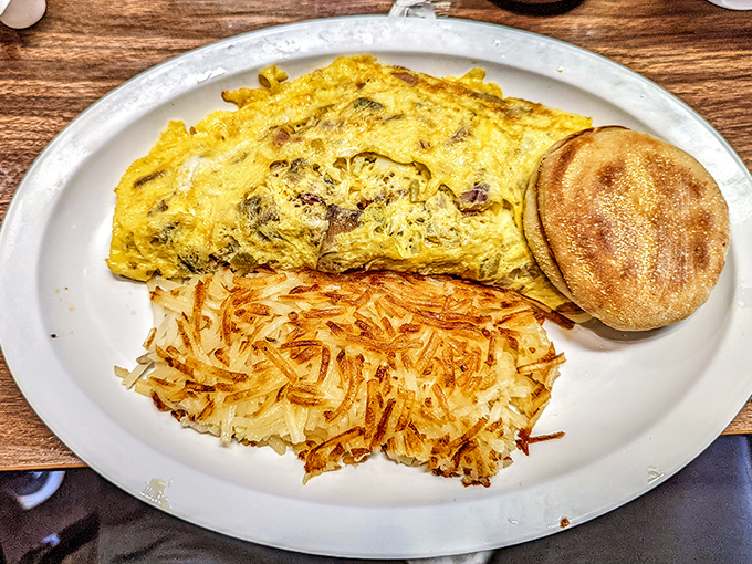Behold the omelet in its natural habitat&mdash;perfectly folded, generously stuffed, and flanked by golden hash browns and an English muffin.