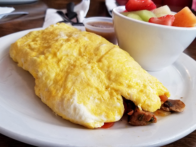 This isn't just an omelet&mdash;it's a fluffy golden envelope delivering a secret message of deliciousness. The fresh fruit side is just showing off.