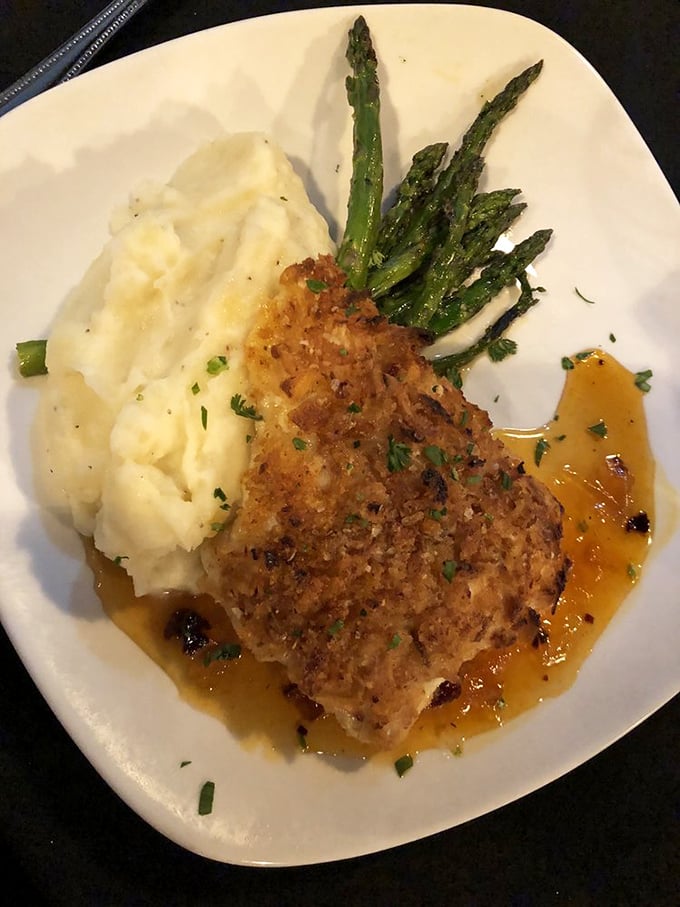 The onion-crusted grouper arrives like royalty on a throne of mashed potatoes, with asparagus courtiers standing at attention.