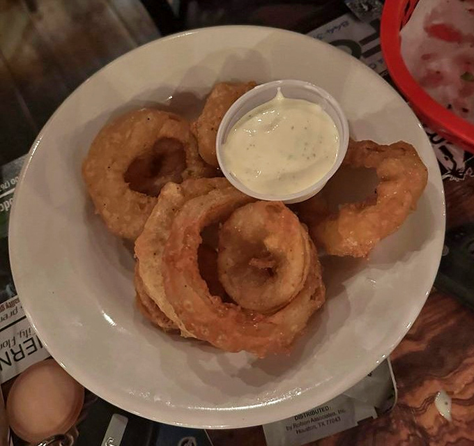 Golden halos of crispy perfection. These aren't just onion rings; they're edible jewelry that people drive across county lines to experience.