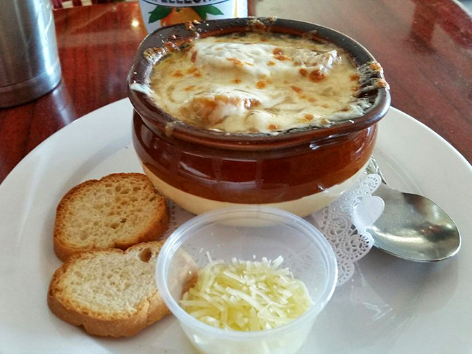 Behold the French onion soup in all its glory! That cheese pull could win Olympic medals, while the broth beneath holds secrets only grandmothers know.