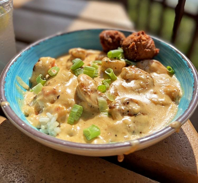 This isn't just seafood stew, it's a maritime symphony in a bowl – tender shrimp swimming in creamy goodness with hush puppies standing guard.