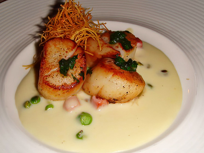 These scallops aren't just seared&mdash;they're transformed into buttery islands of perfection in a sea of velvety sauce. Ocean poetry on a plate.