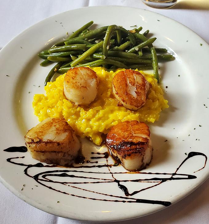 Golden-seared scallops resting on sunny saffron risotto with green beans standing at attention. A plate so pretty it almost deserves its own Instagram account.