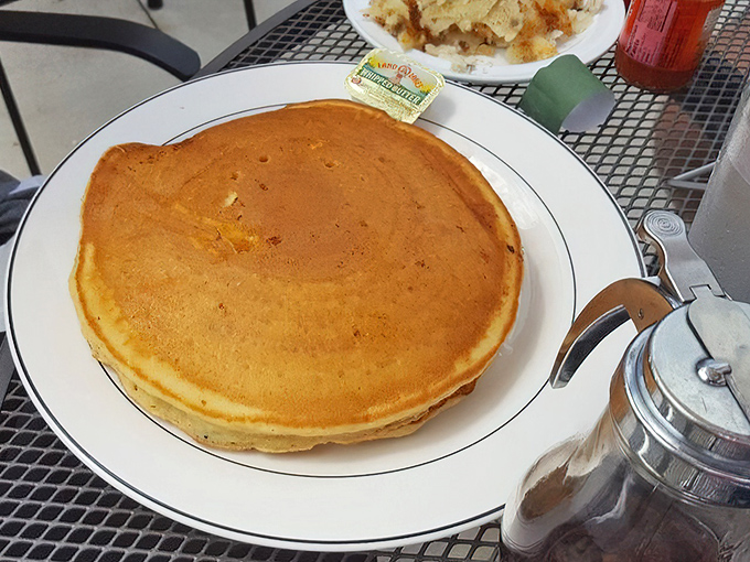 Behold the pancake that ate Manhattan! Golden, fluffy, and taking up real estate on the plate like it's paying rent.