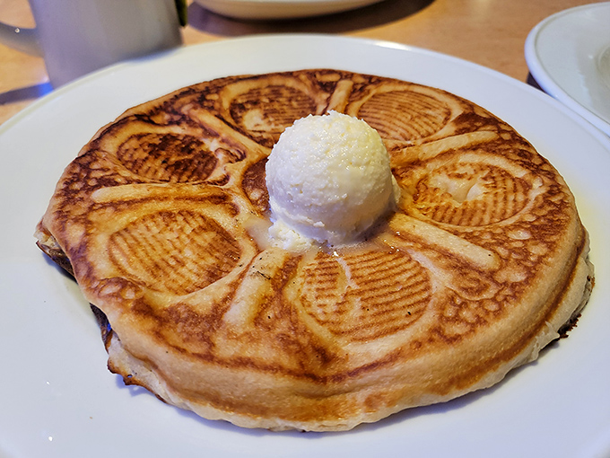 These aren't just pancakes – they're golden circles of happiness topped with a scoop of pure indulgence.