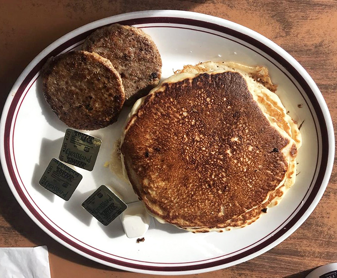 Golden-brown pancakes with a perfect crisp edge paired with sausage patties&mdash;proof that breakfast perfection doesn't require complicated techniques, just respect for tradition.