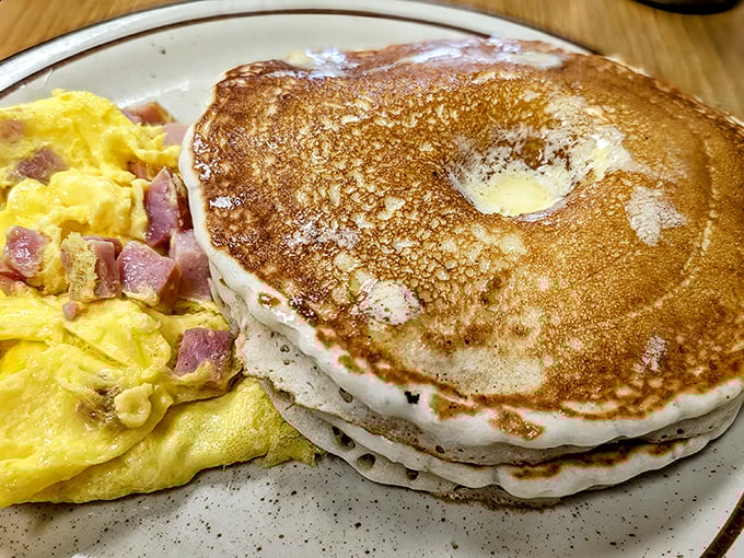 Pancakes stacked higher than your morning ambitions, with an omelet that's practically winking at you from across the plate.