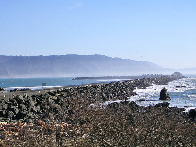 The jetty stretches into the misty horizon like nature's own runway, where waves rather than planes make dramatic arrivals.