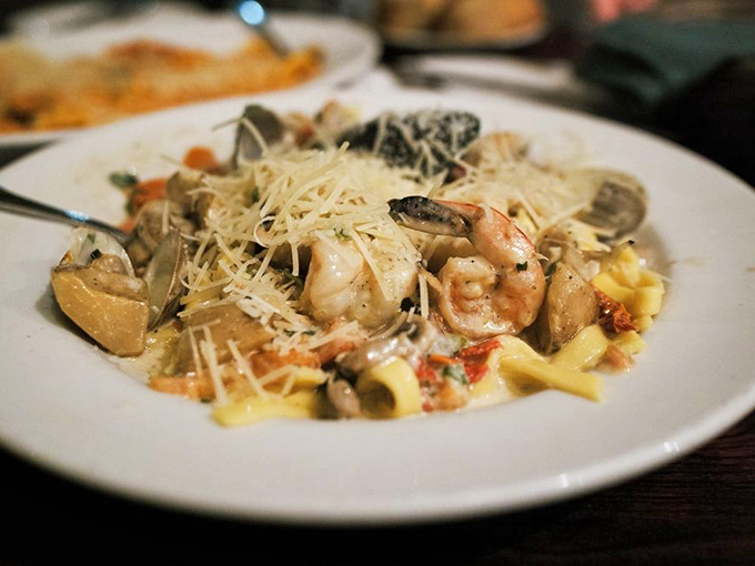 Seafood pasta perfection &ndash; plump shrimp and tender shellfish nestled among fresh pasta, all crowned with a snowfall of Parmesan.