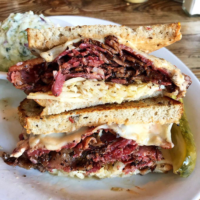 Behold the architectural marvel that is the pastrami sandwich &ndash; a skyscraper of meat that demands both hands and your full attention.