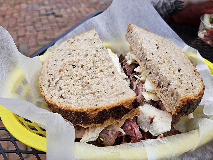 This isn't just a sandwich; it's architecture. Layers of pastrami and slaw creating the skyscraper of flavor your lunch hour deserves.