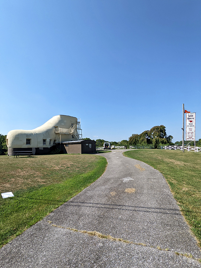 The path to the Shoe House beckons visitors forward. If the yellow brick road led to Oz, this concrete walkway leads to something equally magical.