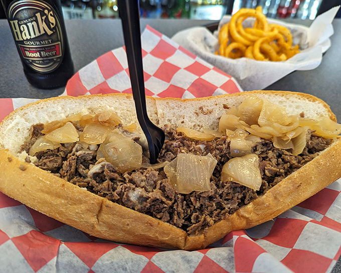 Behold the star of the show: thinly sliced beef, caramelized onions, and molten cheese cradled in a perfect roll. Poetry in sandwich form.