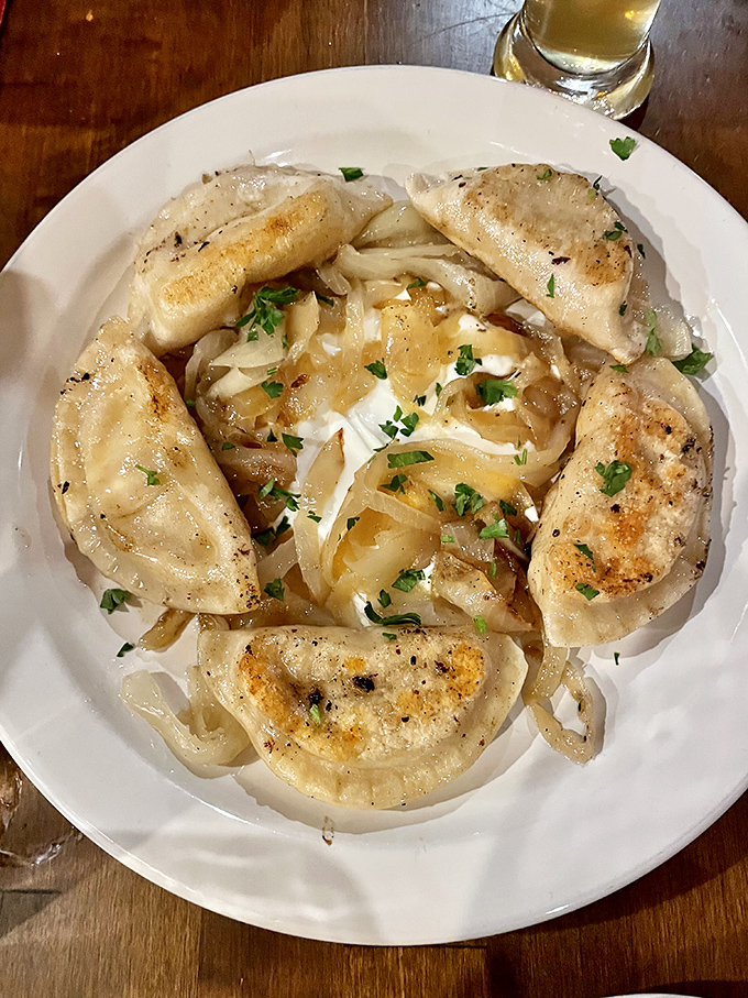 Golden-brown pierogies glisten with butter, arranged like treasures around caramelized onions. These aren't your babcia's dumplings&mdash;though she'd certainly approve.