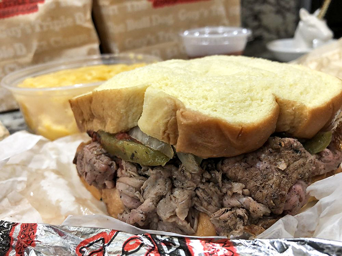 Behold the architectural marvel that is Chaps' pit beef sandwich. Those pickles aren't garnish—they're the perfect acidic counterpoint to meat nirvana.