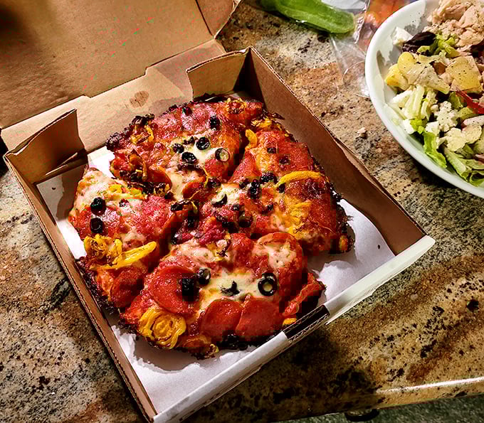 Pizza that makes you question every life decision that didn't involve eating this sooner. Those pepperoni cups are tiny pools of flavor heaven.