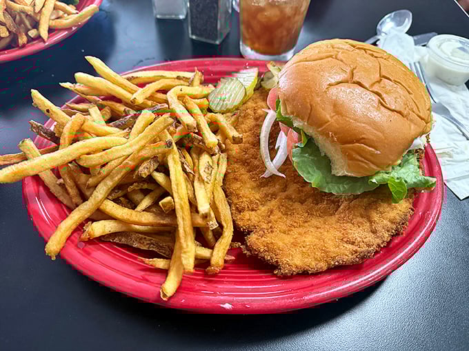 Behold the star attraction: a tenderloin so magnificently oversized it makes the bun look like it's playing a supporting role.