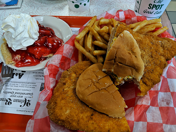 The breaded pork tenderloin sandwich spills gloriously over its bun, a Midwest tradition that laughs in the face of sensible portion sizes.