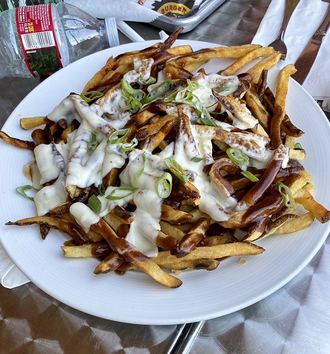 These loaded fries aren't just a side dish &ndash; they're a main event dressed in melty cheese, green onions, and pure joy.