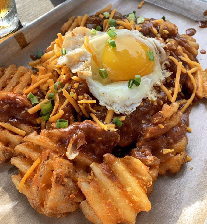Breakfast meets BBQ in this waffle fry poutine topped with a sunny-side-up egg &ndash; the morning-after remedy you never knew you needed.
