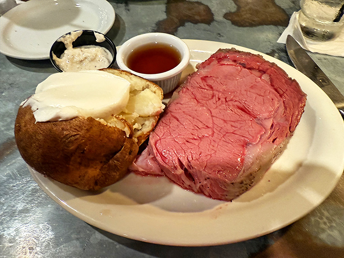 Behold the star of the show: prime rib so perfectly pink it could make a vegetarian question their life choices, paired with a potato worthy of its own fan club.
