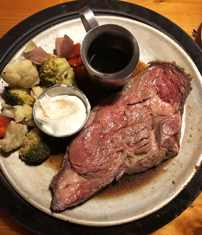 Prime rib perfection: a rosy center, seasoned crust, and vegetables that somehow don't feel like punishment next to such beefy glory.